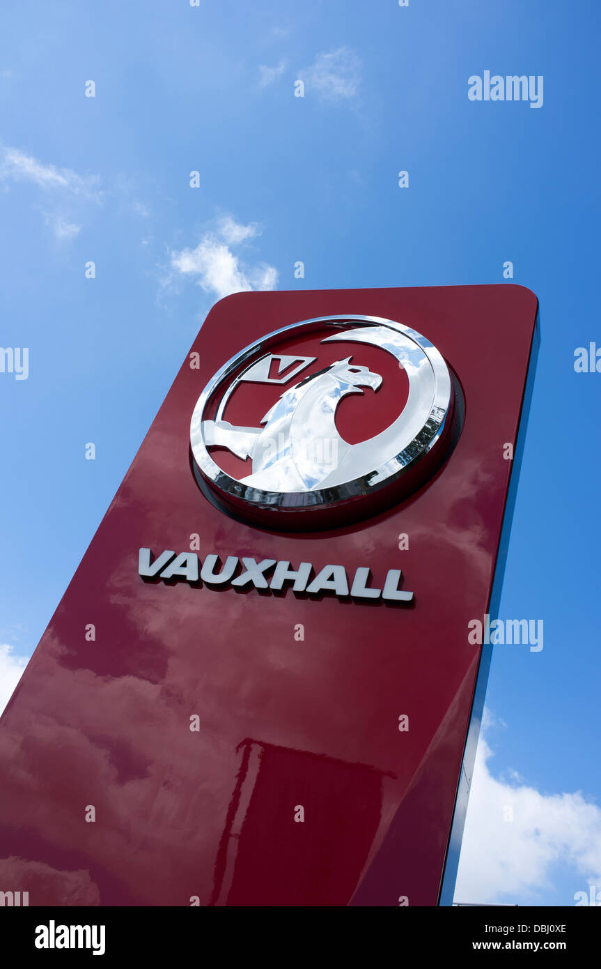 Looking up at Vauxhall car sign and logo with blue sky behind Stock ...