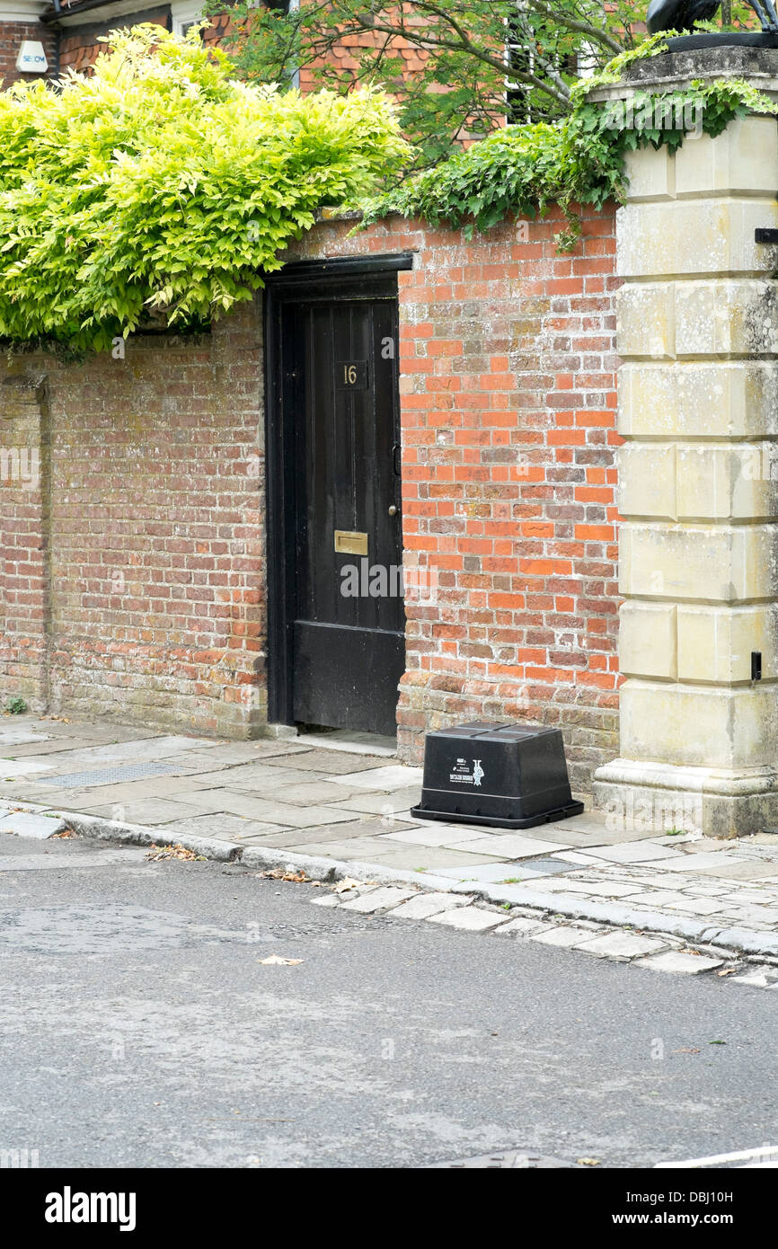 Emptied UK recycling black box left on pavement outside entrance to ...