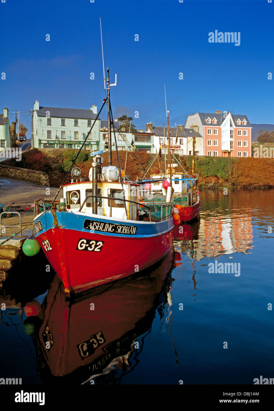 Fishing boats, early morning in the harbour of the Connemara village of ...