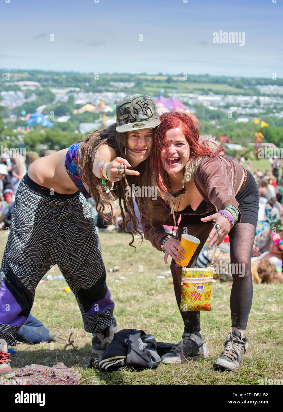 Glastonbury Festival 2013 UK Two girls strike a pose near the stone ...