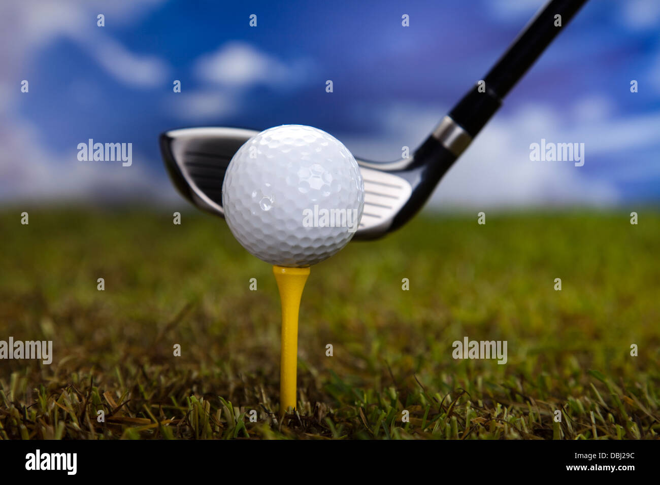 Playing golf, ball on tee Stock Photo - Alamy