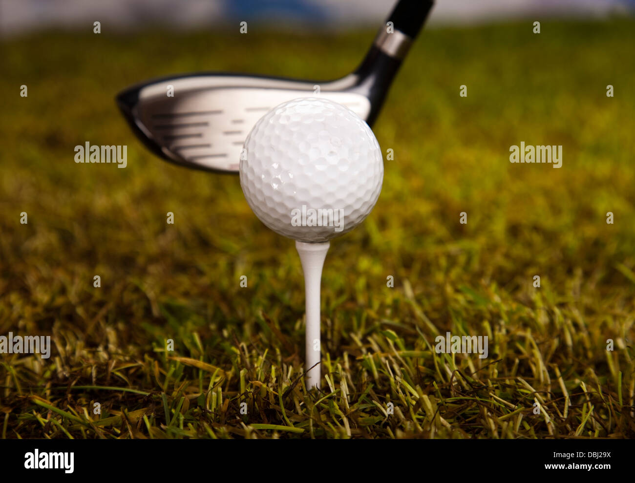 Playing golf, ball on tee Stock Photo - Alamy