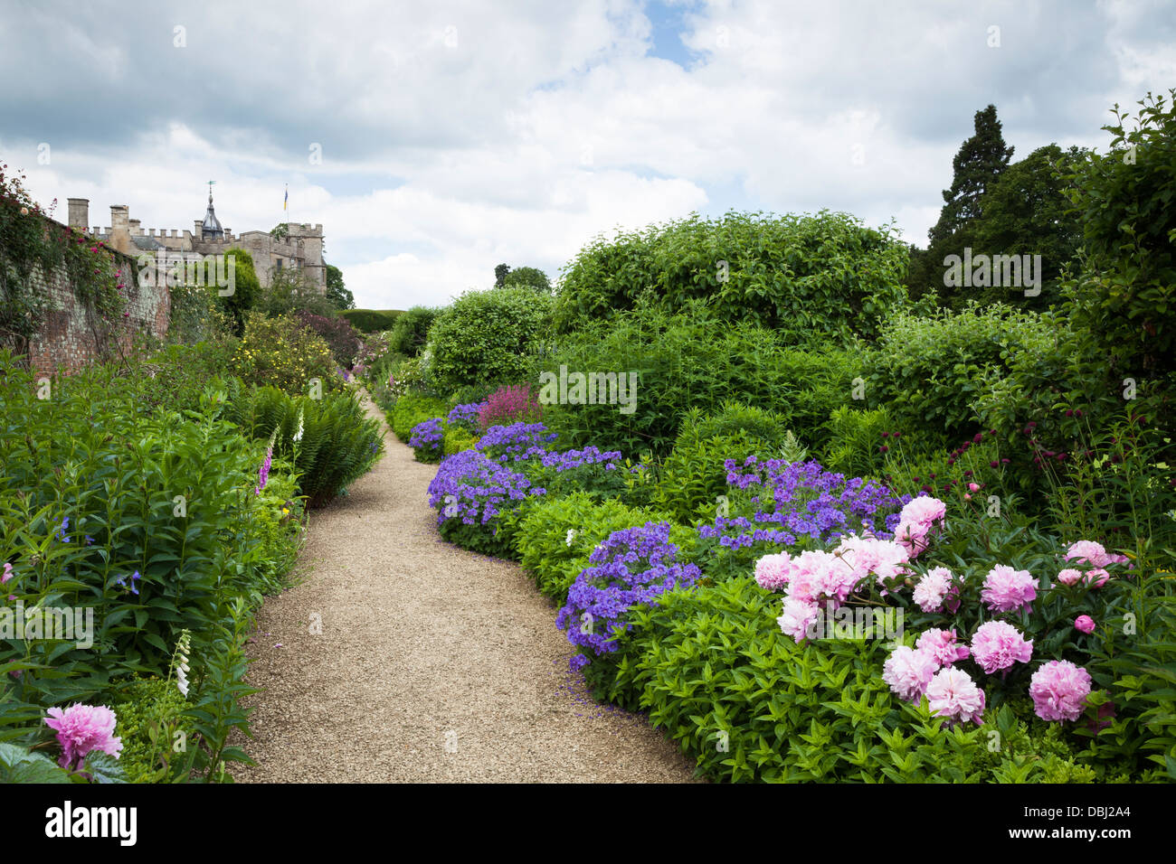 Rousham House glimpsed from within the walled garden with a wide gravel ...