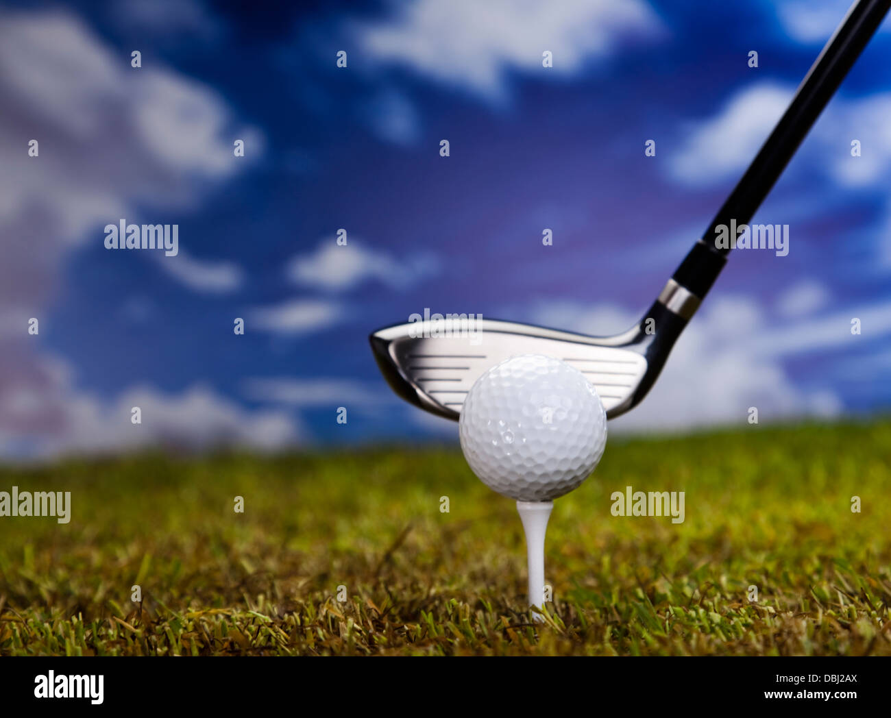 Playing golf, ball on tee Stock Photo - Alamy