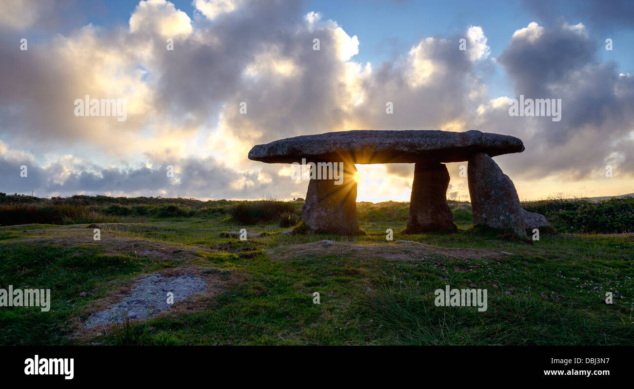 A star burst of sun gleaming through Lanyon Quoit an ancient neolithic ...