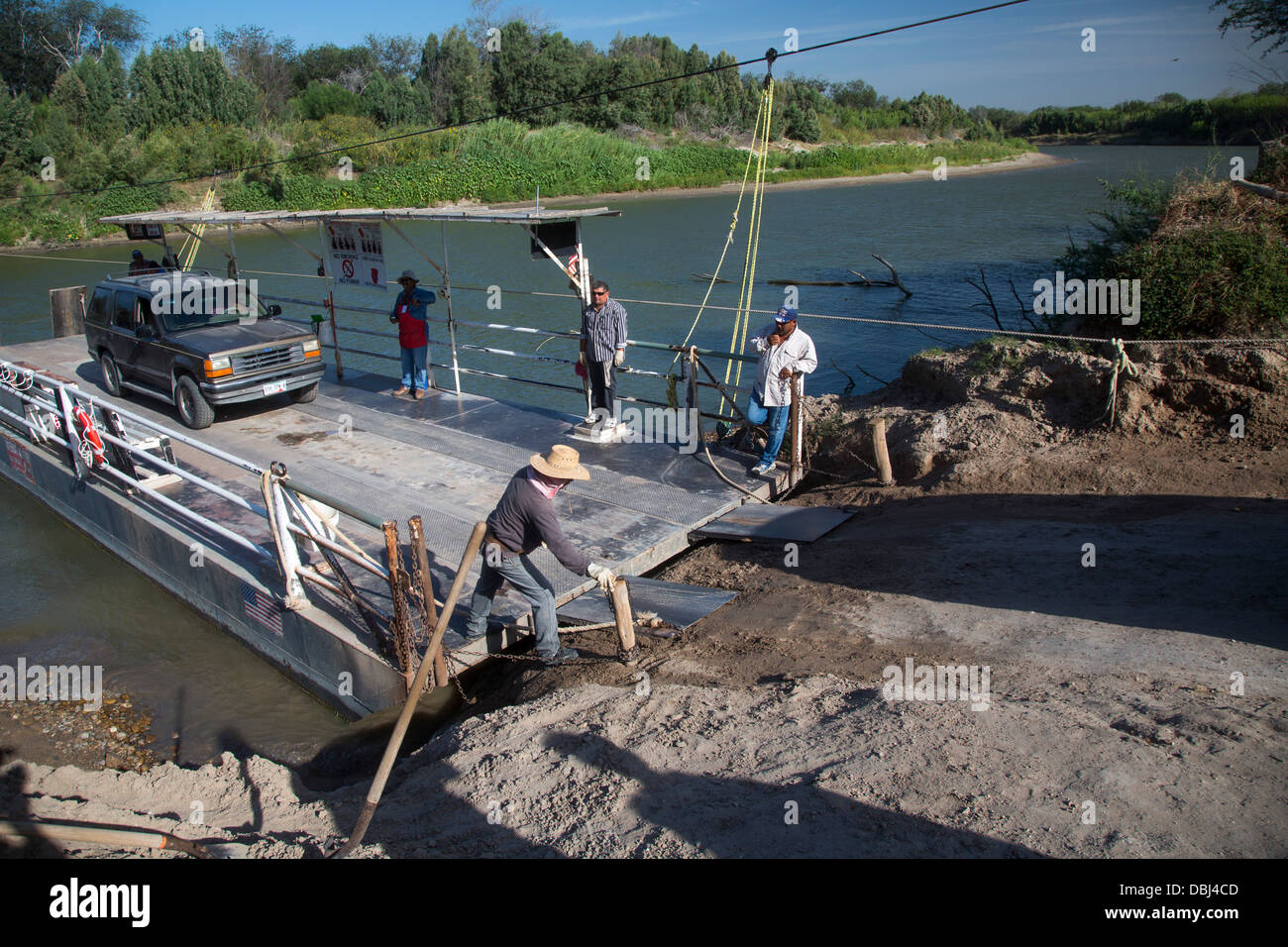 The hand-pulled car ferry which crosses the Rio Grande river between ...