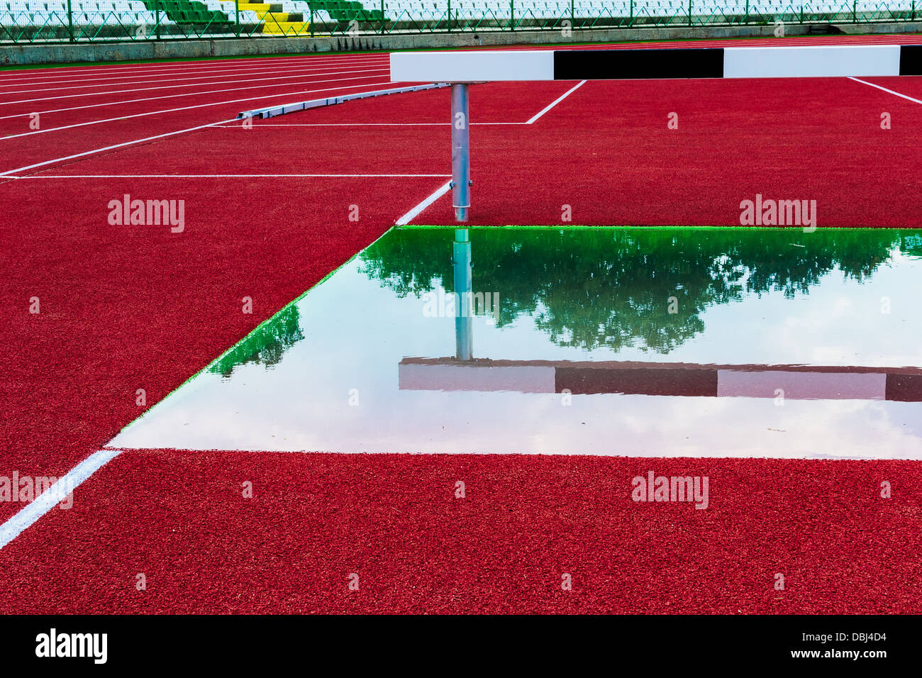 Athletic track with hurdle to jump over water Stock Photo - Alamy