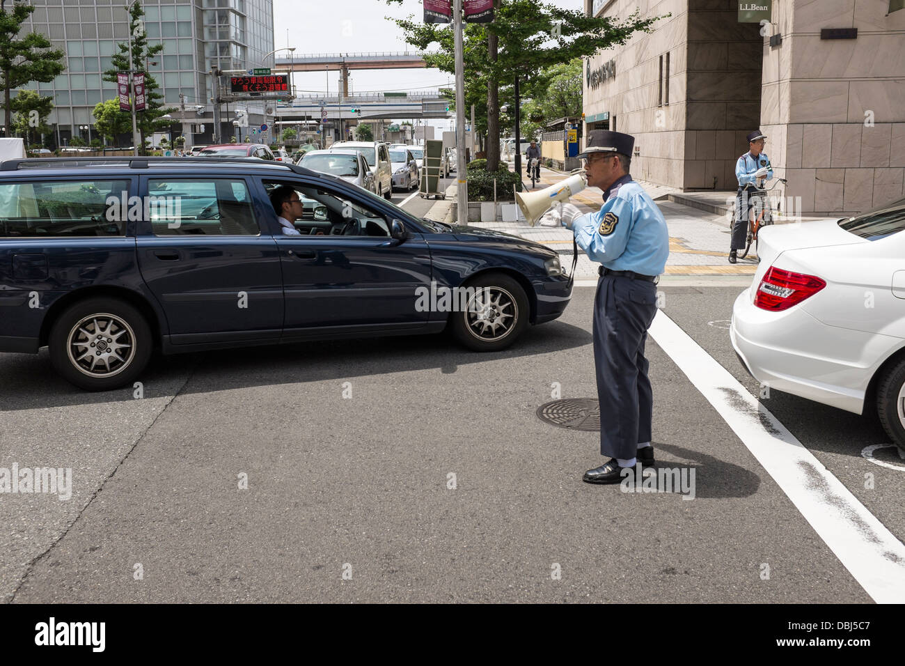 Police directing traffic in Kobe Japan Stock Photo - Alamy