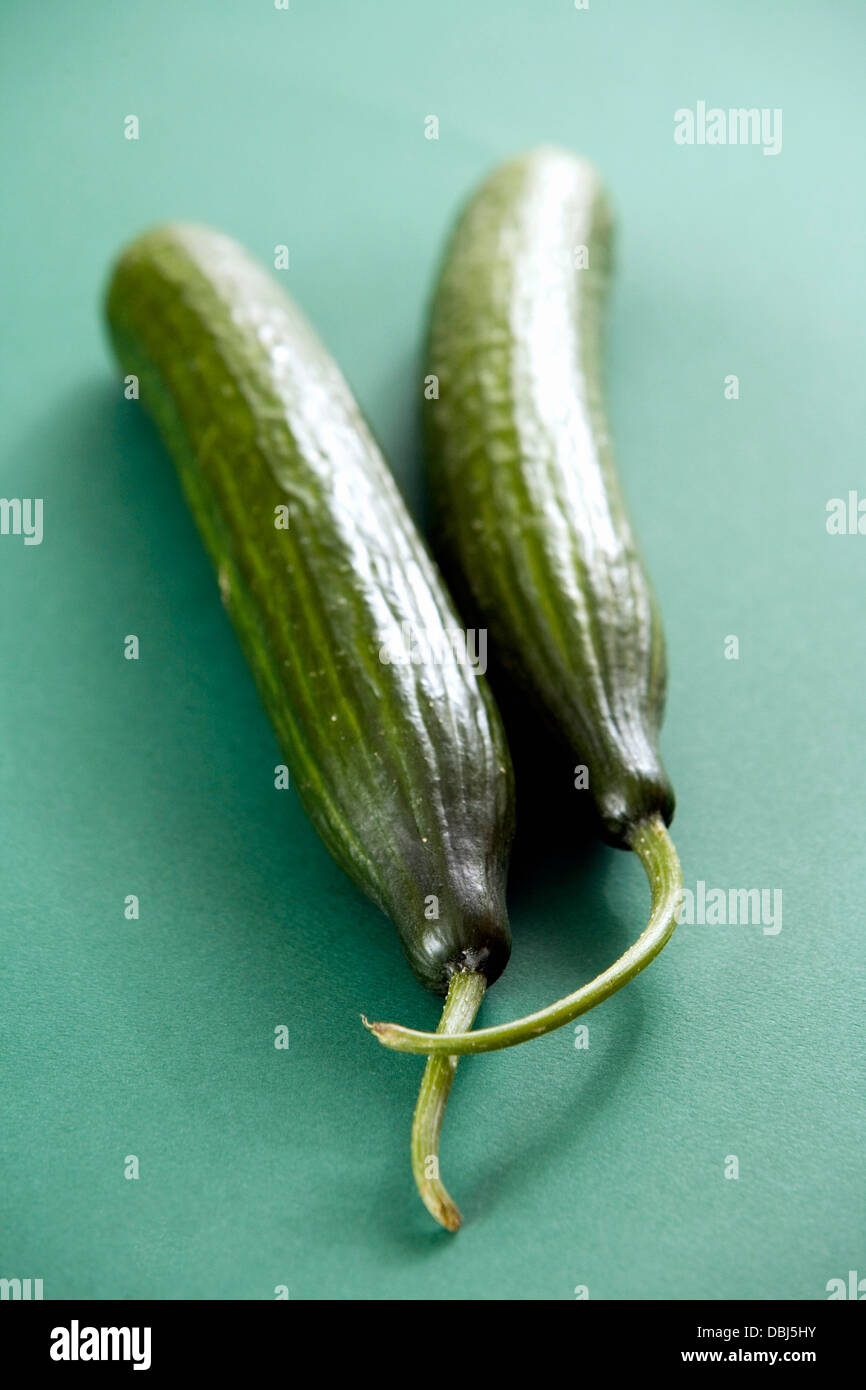 Cucumbers, green background Stock Photo - Alamy