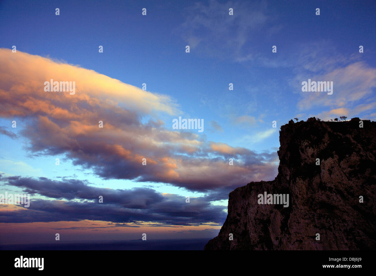 Cliffside with sunset sky Stock Photo - Alamy