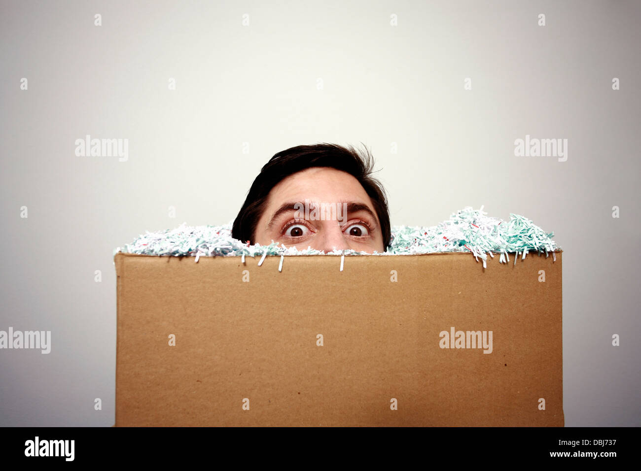 Office worker with head in a box Stock Photo - Alamy