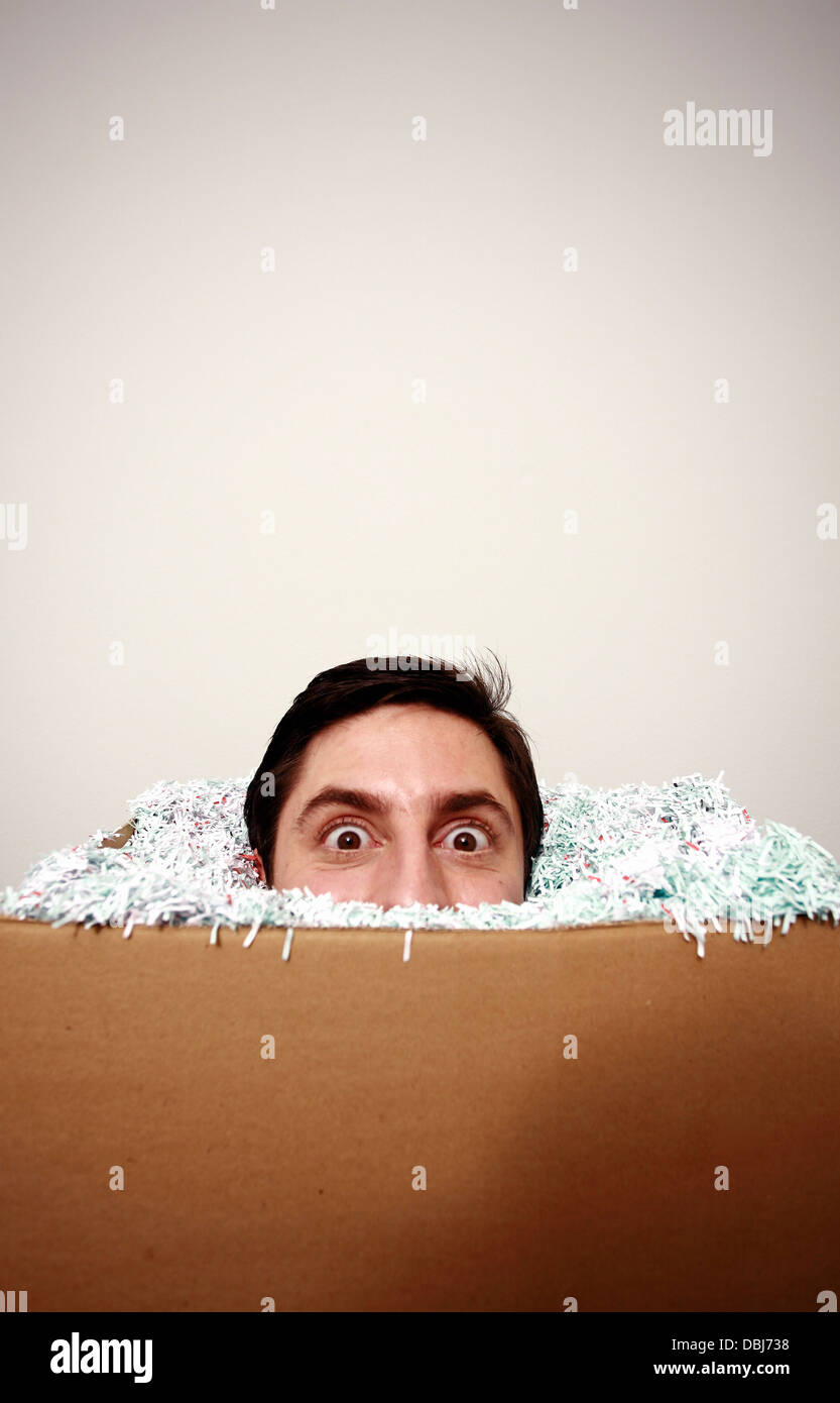 Office worker with head in a box Stock Photo - Alamy