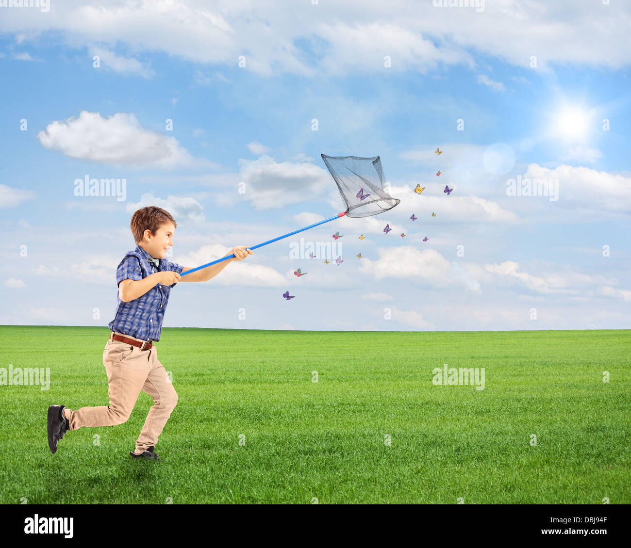 Full length portrait of a child running and catching butterflies with ...