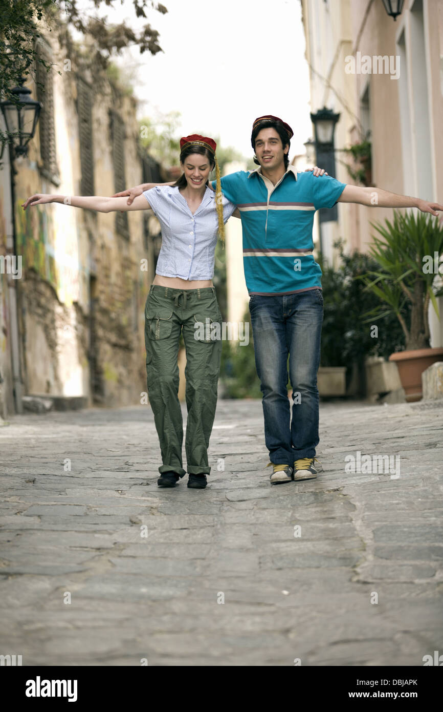 Couple with Greek costume hats dancing Stock Photo - Alamy
