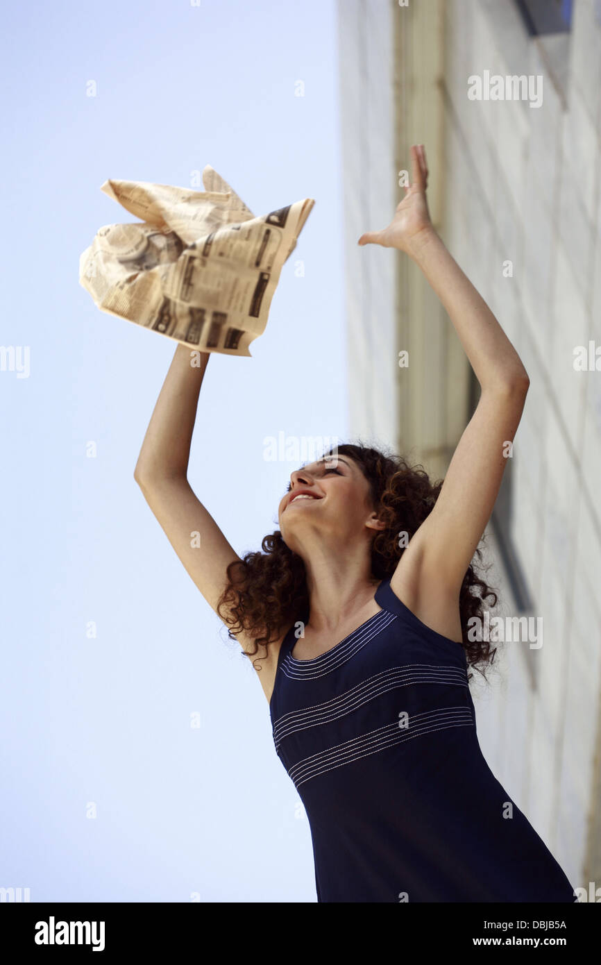 Happy businesswoman throwing newspaper in the air Stock Photo - Alamy