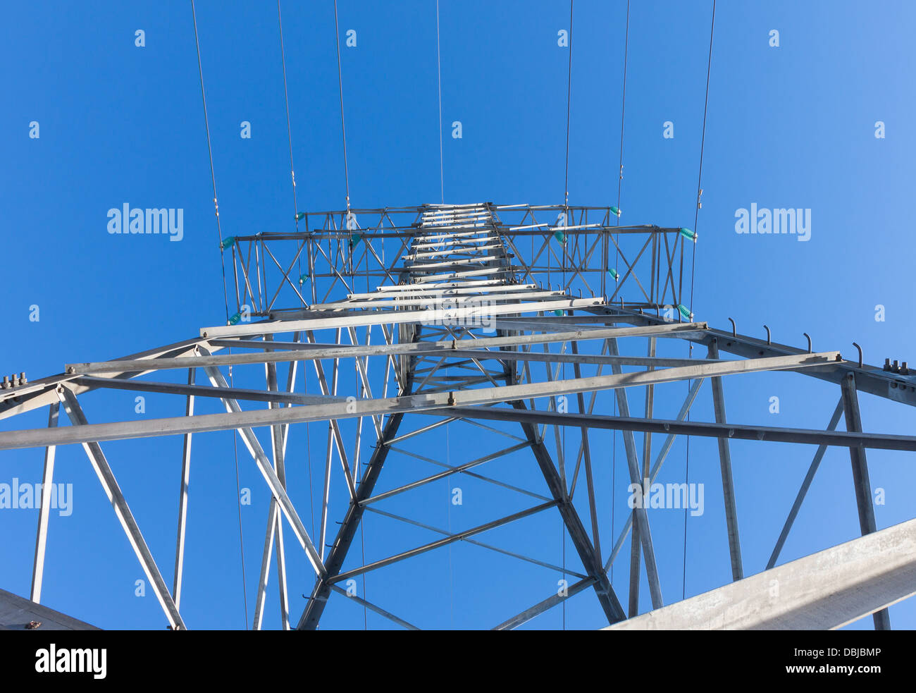 a long line of electrical transmission towers carrying high voltage ...
