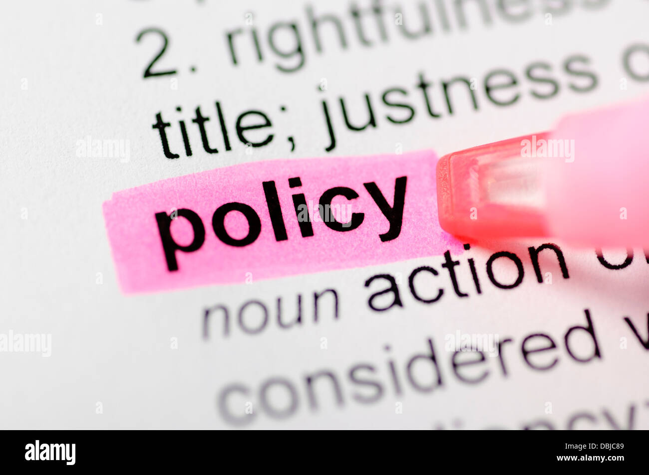 Pink marker on policy word Stock Photo - Alamy