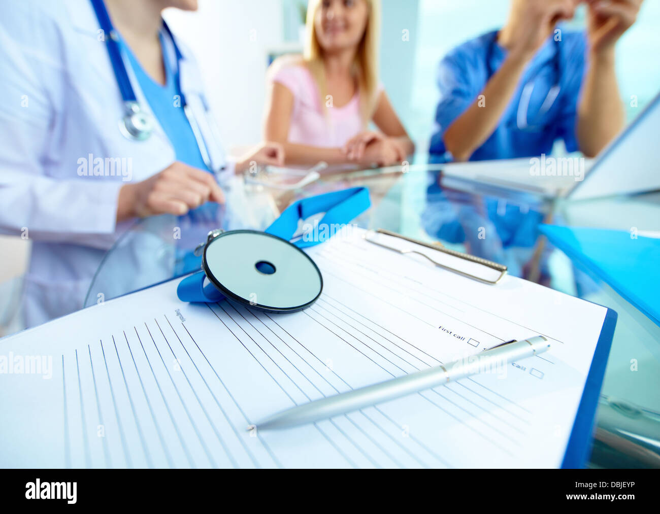 Close-up of medical equipment and document on background of doctors and ...