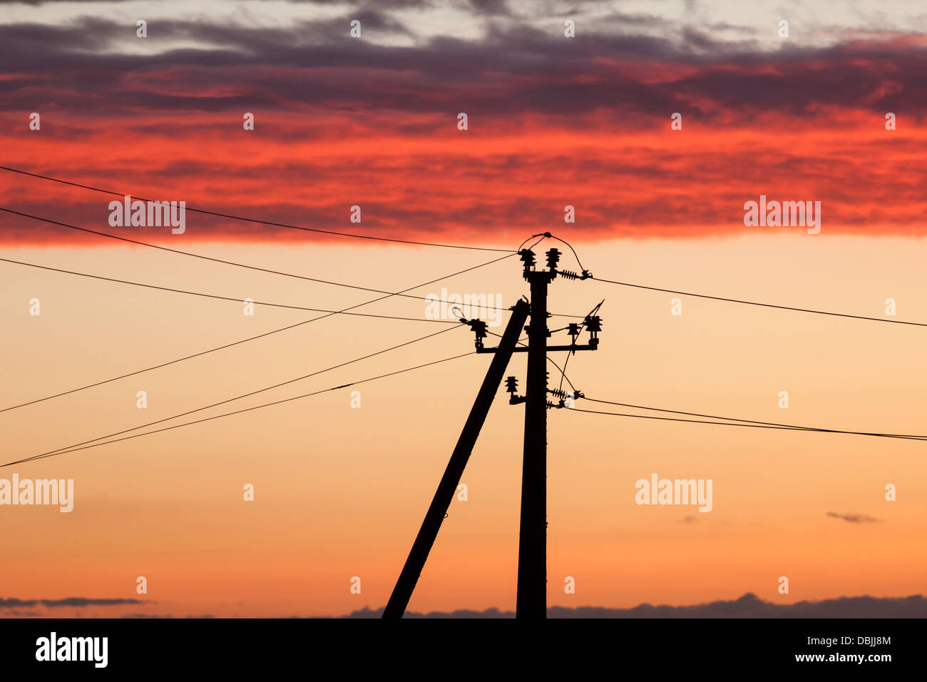 Electric power line against colorful sky at sunset Stock Photo - Alamy