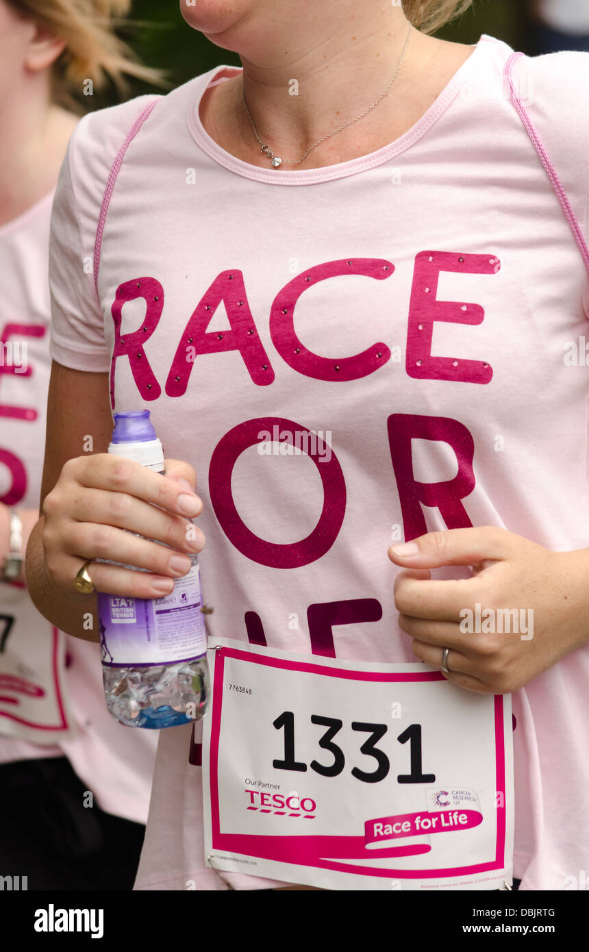 Woman running in a race for life UK Stock Photo - Alamy