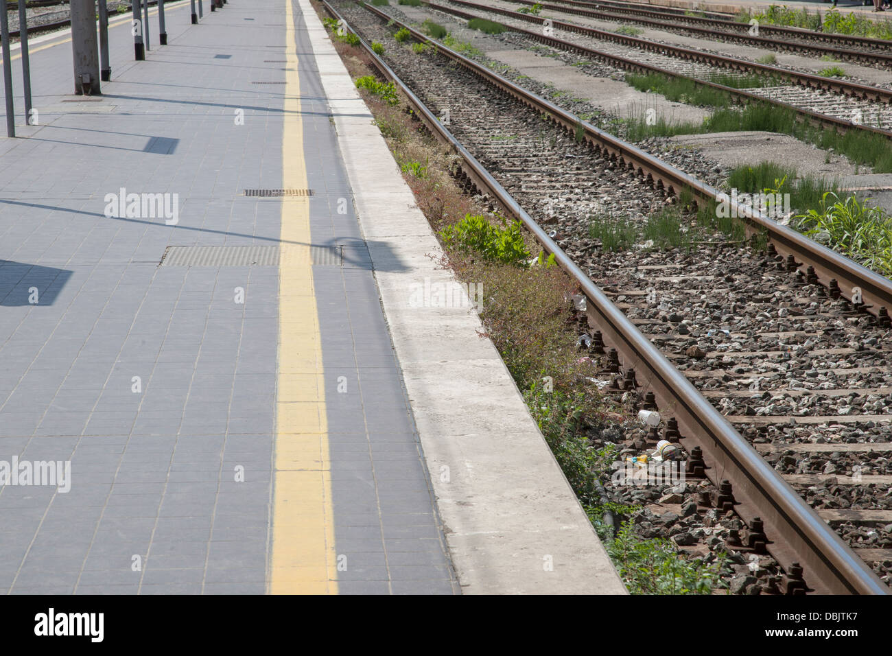 Railroad Tracks and Platform with Yellow Safety Line Stock Photo - Alamy