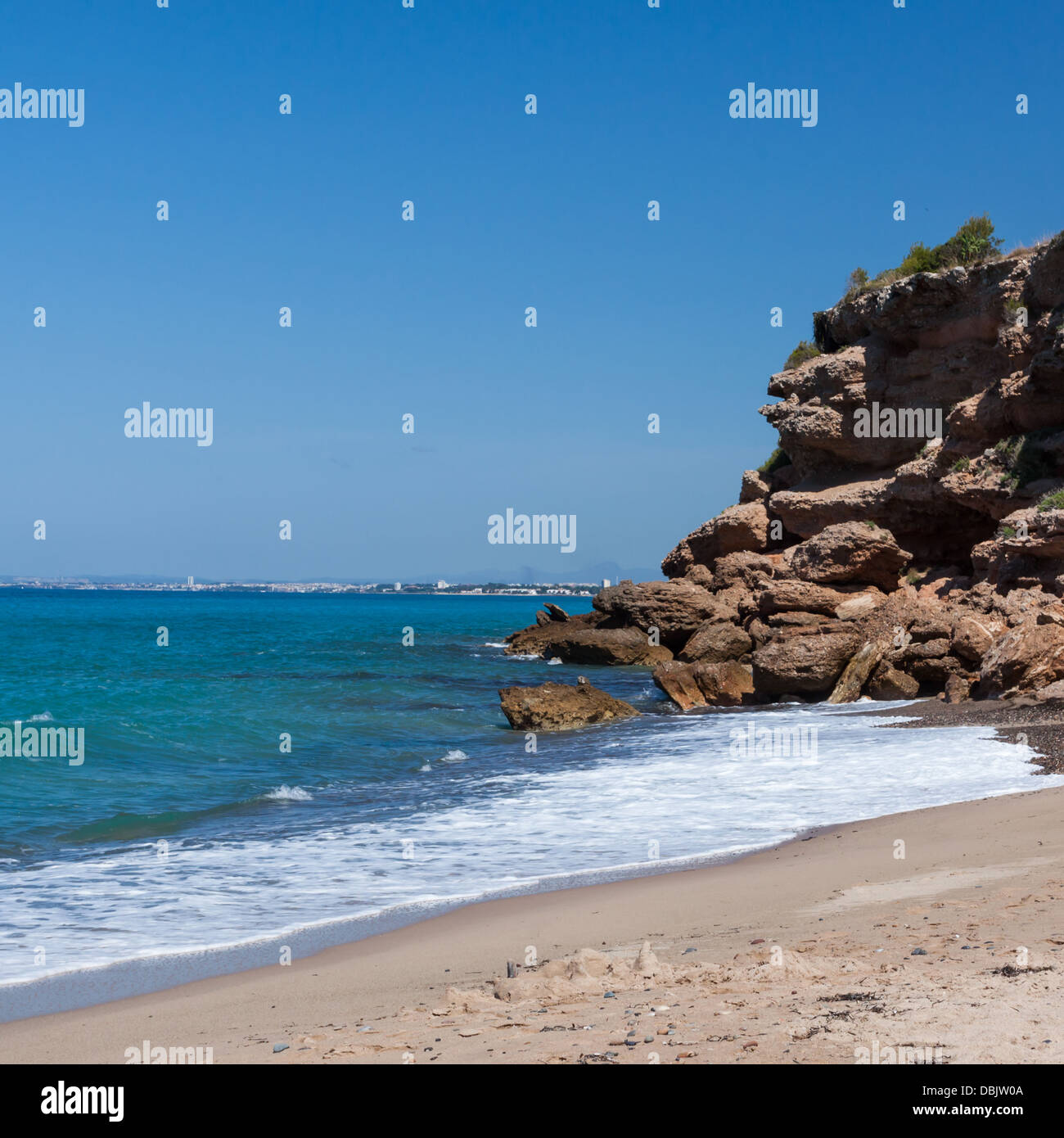 Beautiful small sandy beach in Spain. With rock and tree Stock Photo ...
