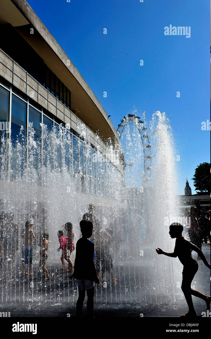 Adults and Children soak in a temporary water fountain on the South ...