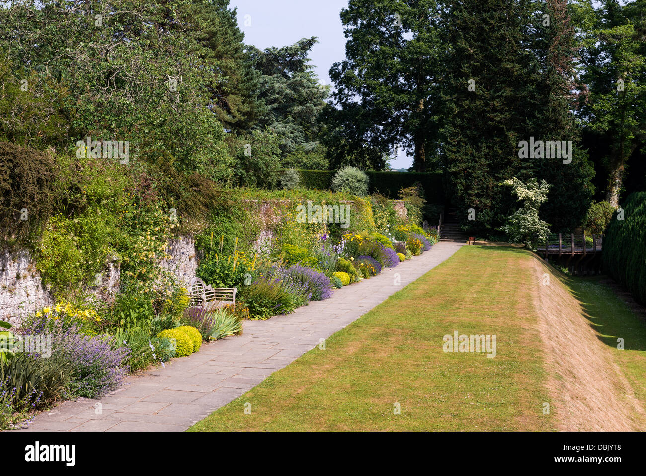 Dartington, Devon, England. July 15th 2013. Pathway and garden seat ...
