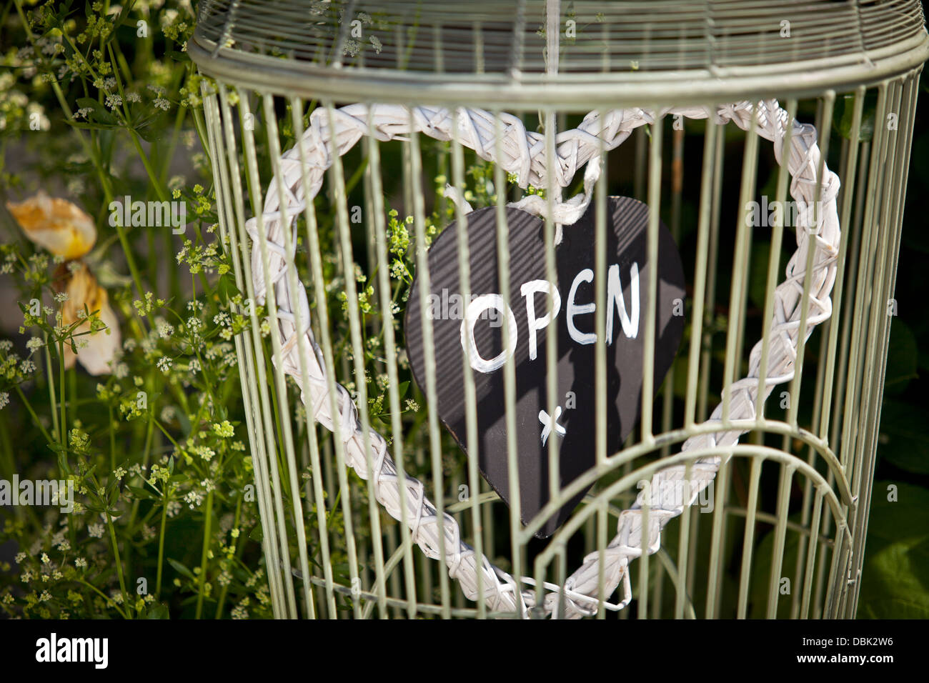 Open sign in a birdcage hanging in the sunshine Stock Photo - Alamy