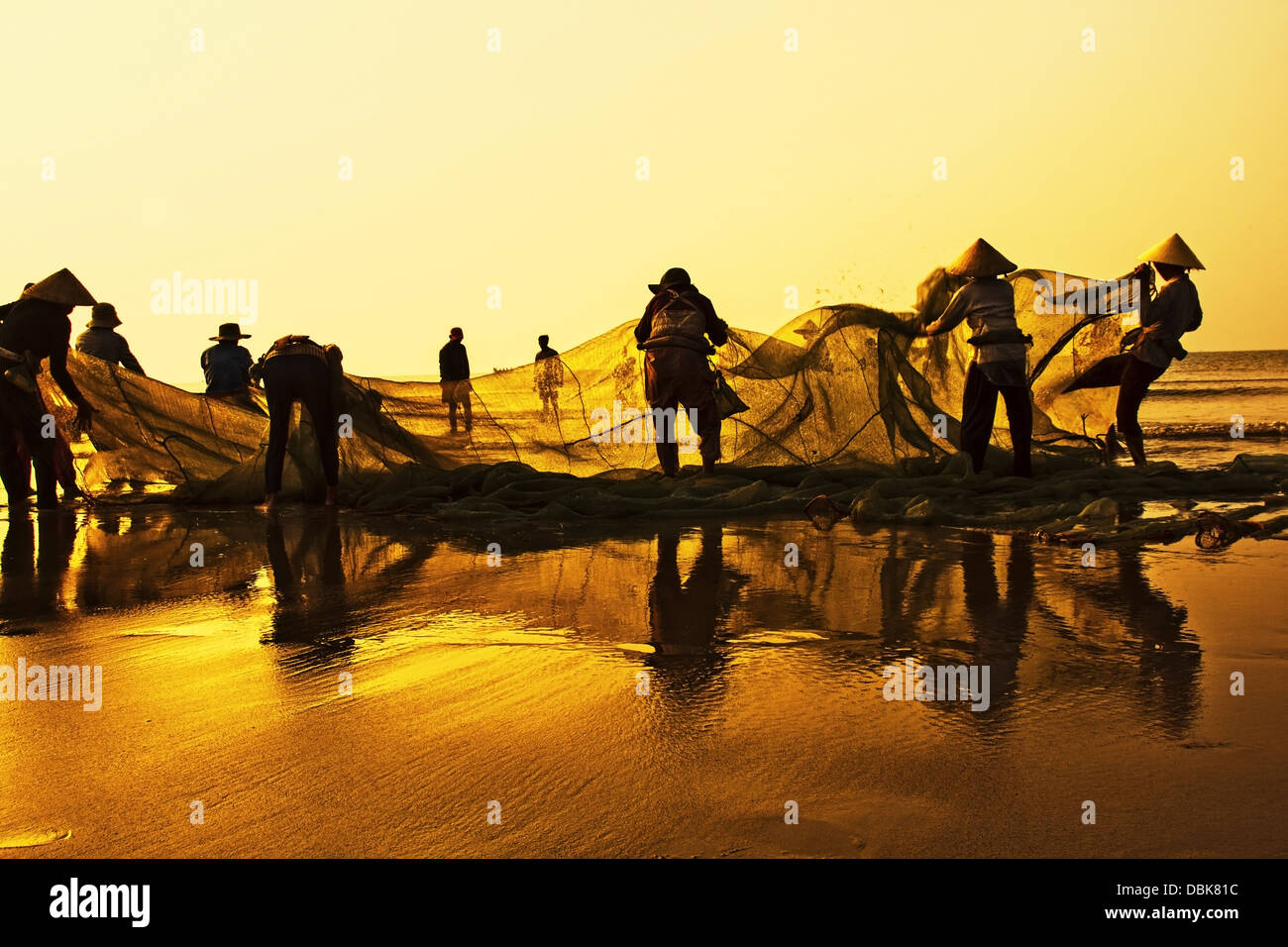 The fishermen are pulling fishing nets on the shore Stock Photo - Alamy