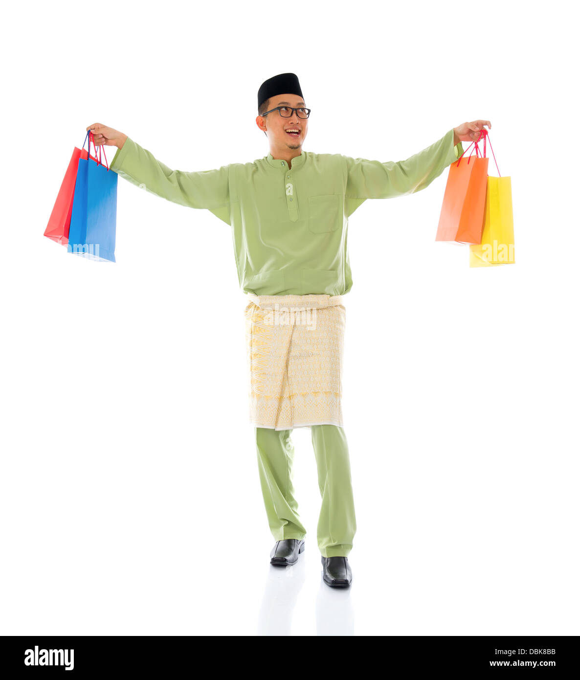 Traditional Malay male shopping and jumping in joy during hari raya ...