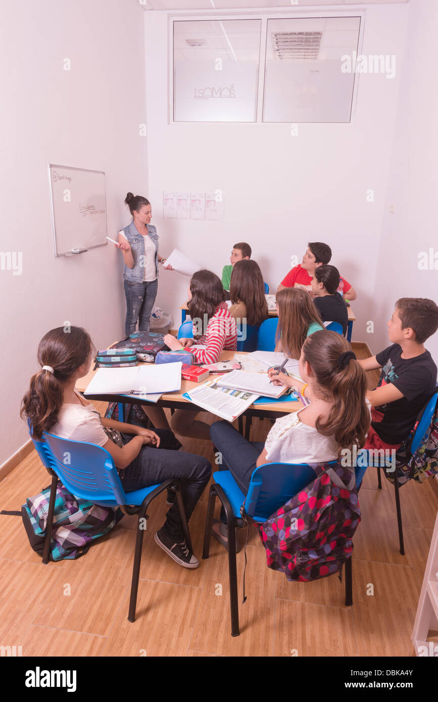 Children and teacher in a classroom Stock Photo - Alamy