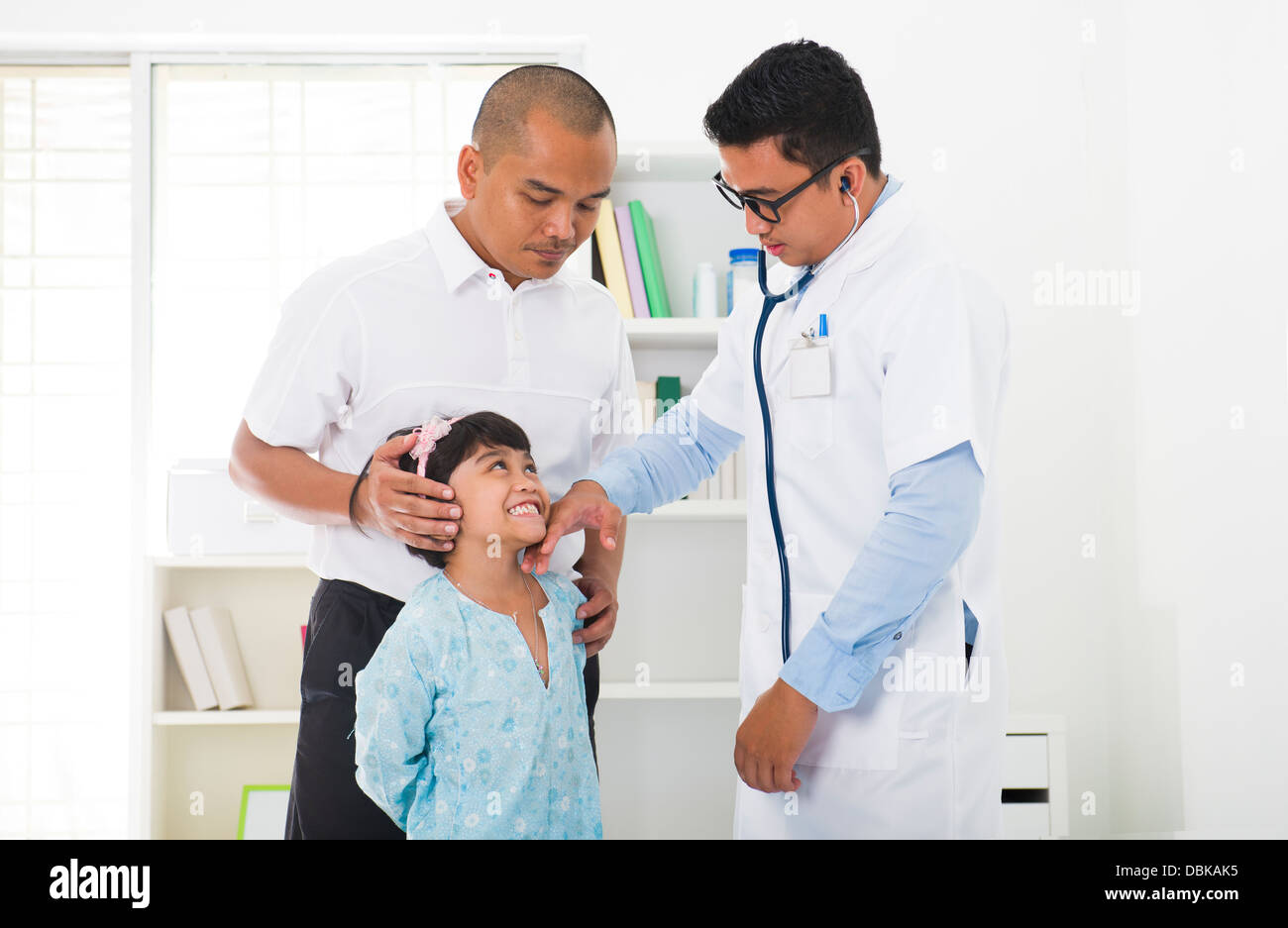 malay father and sick daugther visiting the doctor Stock Photo - Alamy
