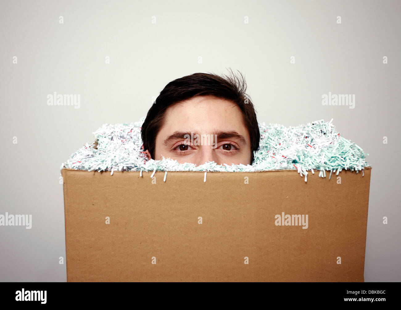 Office worker with head in a box Stock Photo - Alamy