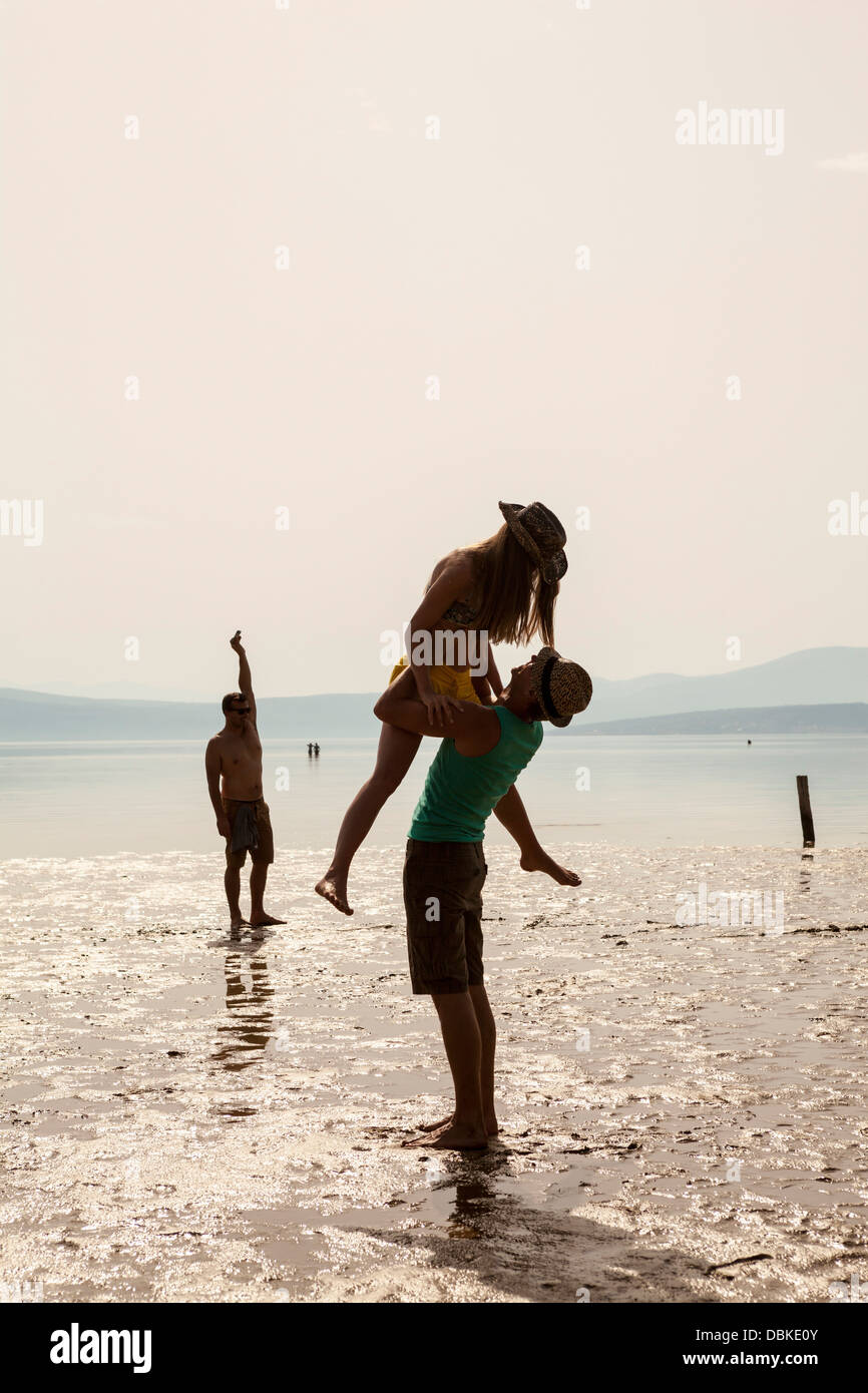 Croatia, Young couple on beach fooling about Stock Photo - Alamy