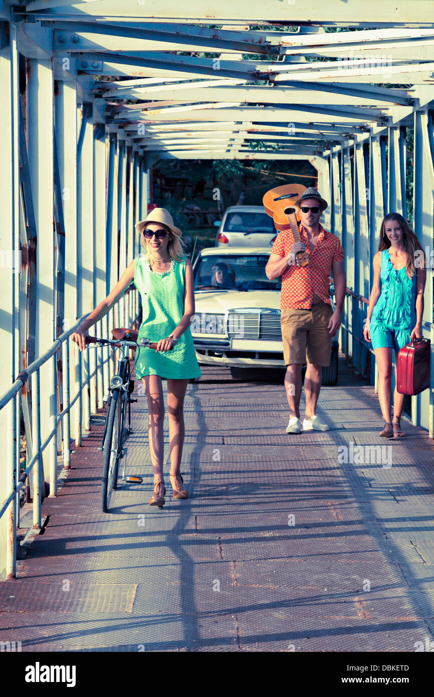 Croatia, Dalmatia, Young people walking along footbridge, cars in ...