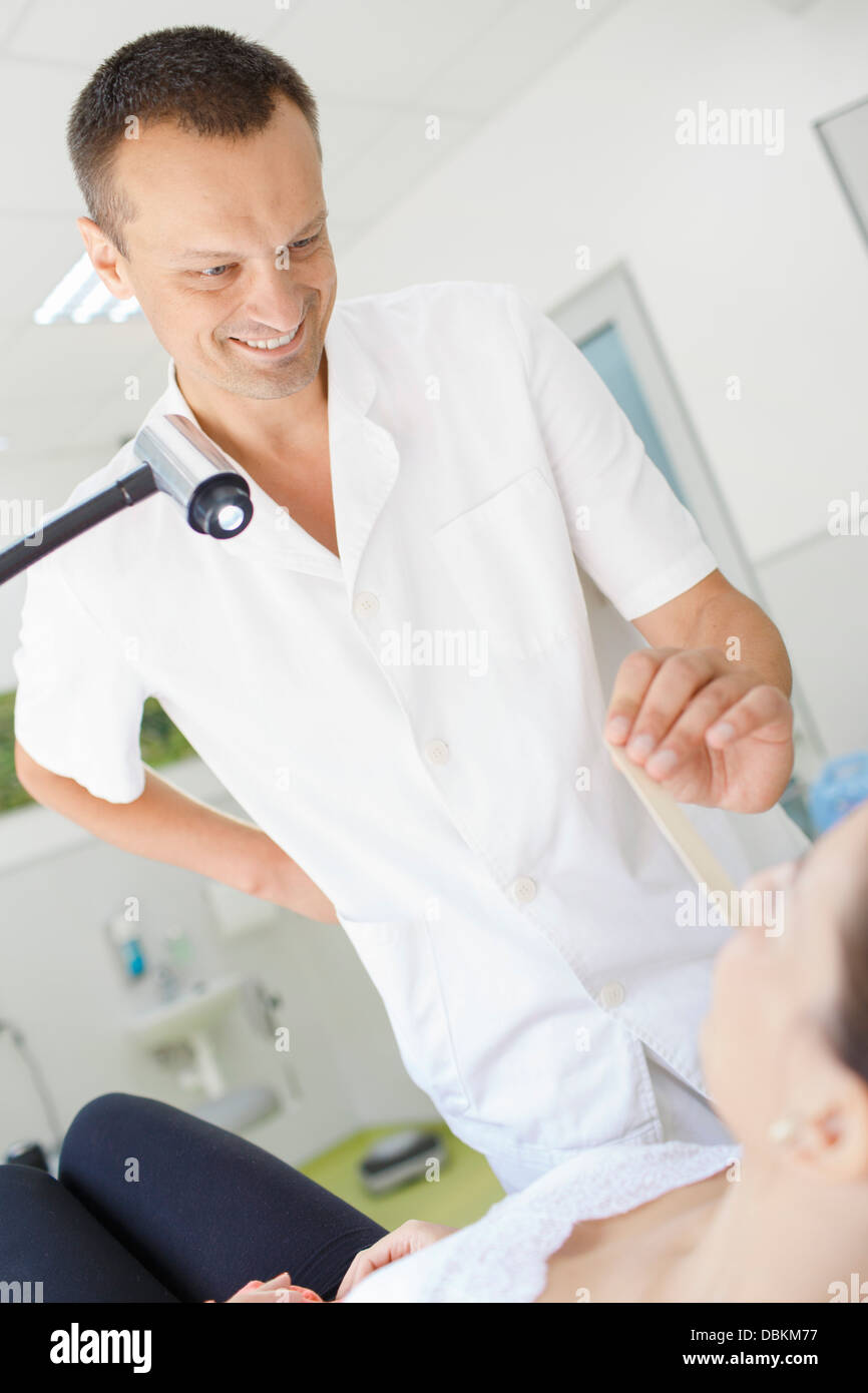 ENT physician Examines the Throat of a Female Patient Stock Photo - Alamy
