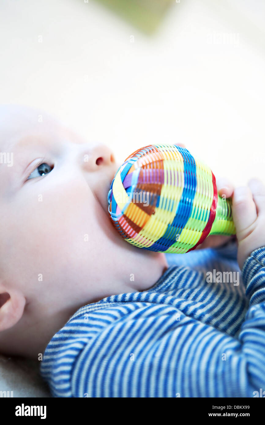 Baby boy playing with rattle, Munich, Bavaria, Germany Stock Photo - Alamy