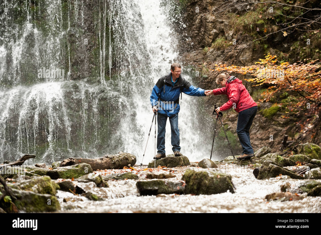 Couple In Front Of A Waterfall, Crossing Brook, Bavaria, Germany ...