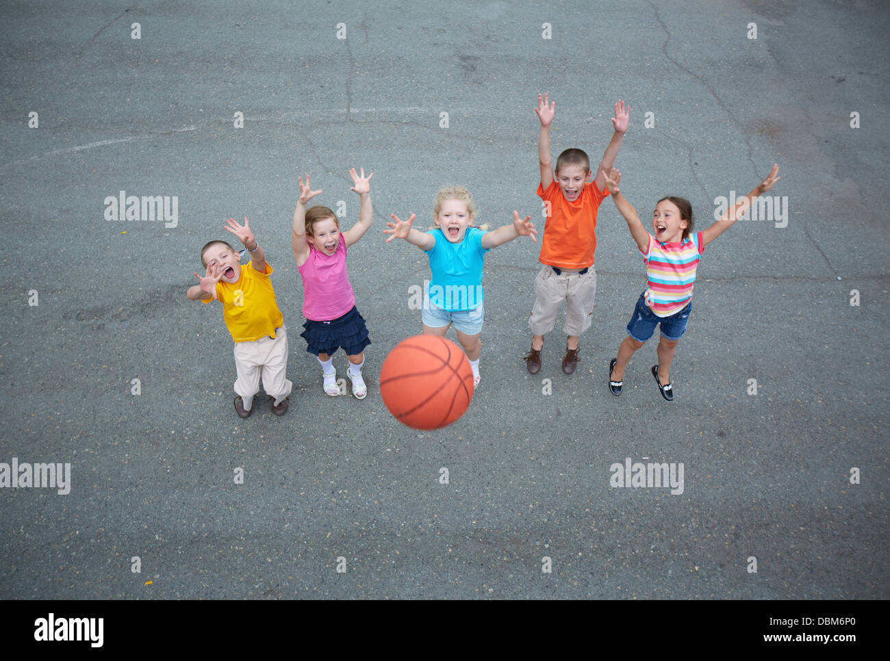 Image of happy friends playing basketball on sports ground Stock Photo ...