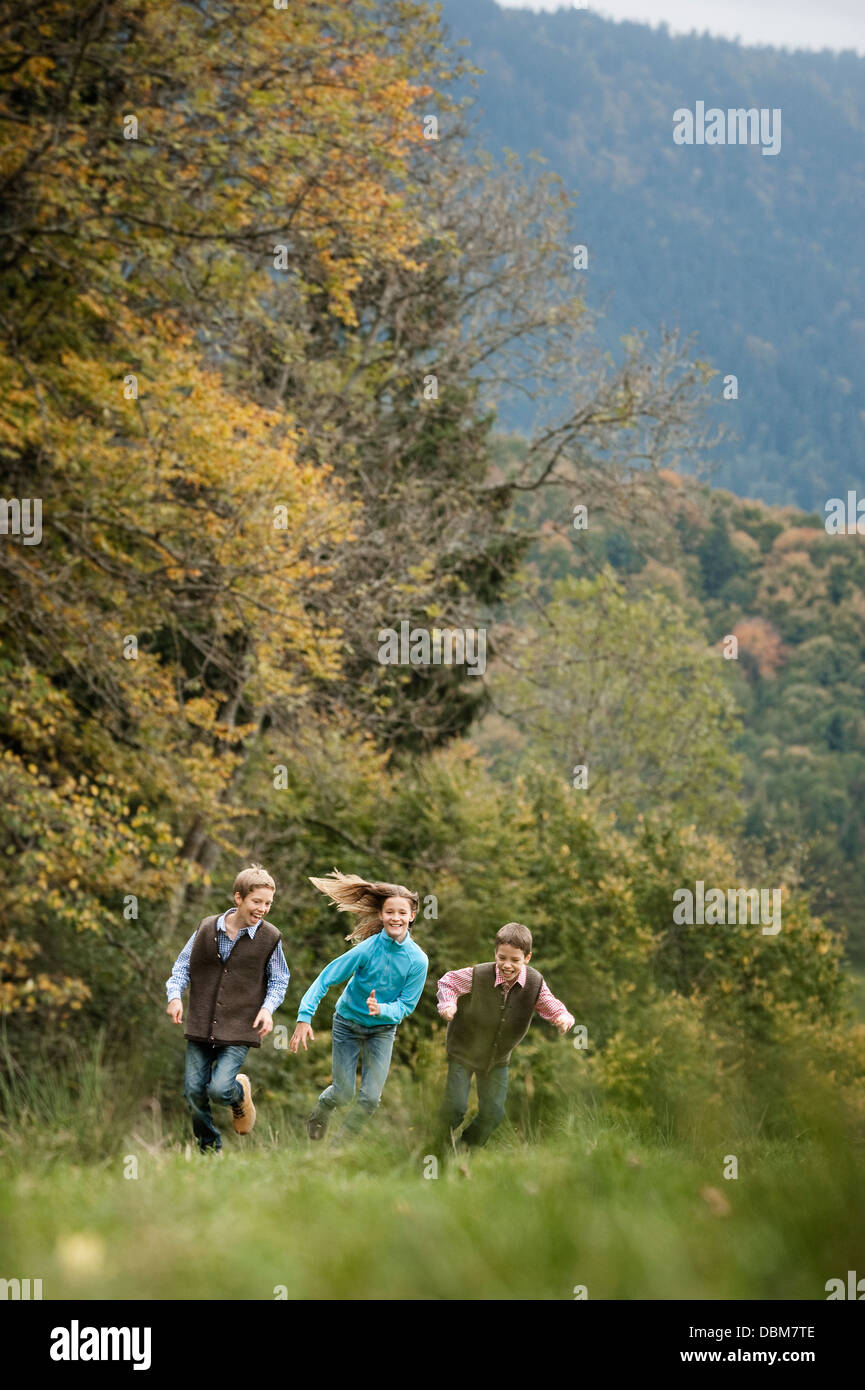 Three Children Running In Field, Bavaria, Germany, Europe Stock Photo ...