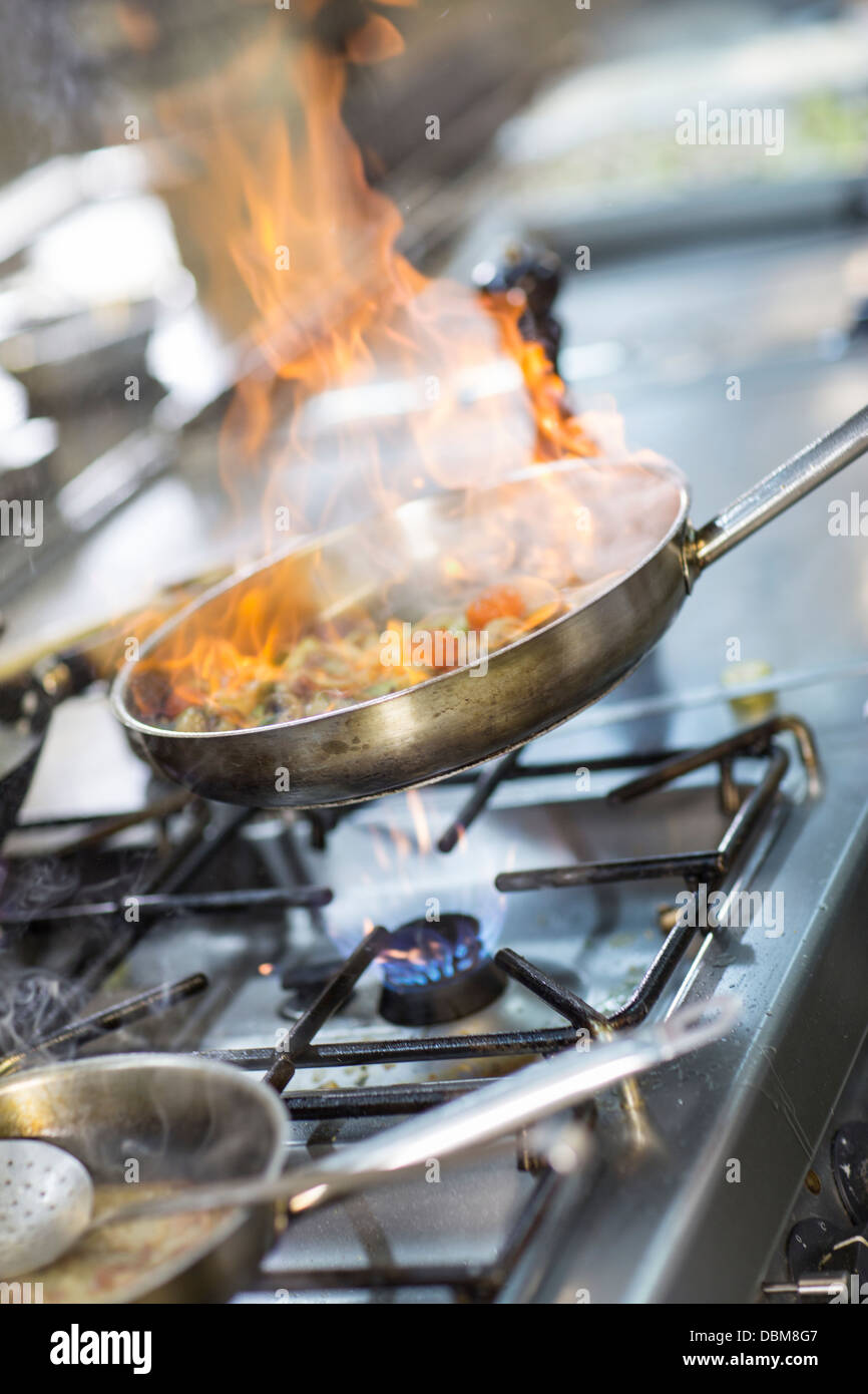 Flambeing Food In Pan Stock Photo - Alamy