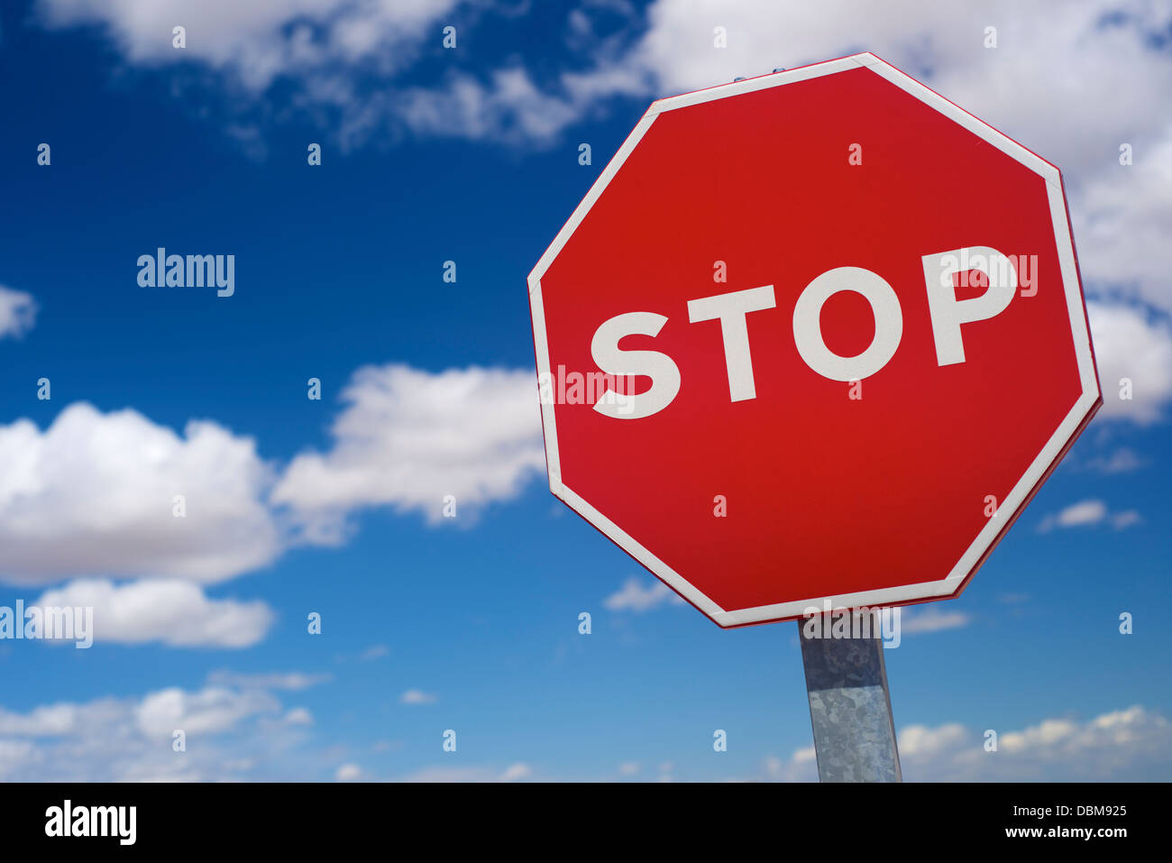 Stop sign and blue sky with white clouds Stock Photo - Alamy