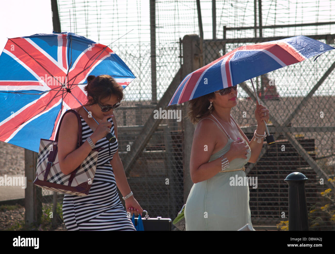 On a sunny day in Brighton,Union Jack Flag umbrellas are used for shade ...