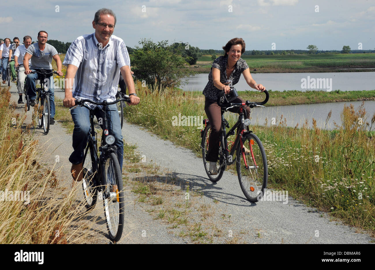Premier of Brandenburg Matthias Platzeck (L) cycles along the Elbe dike ...