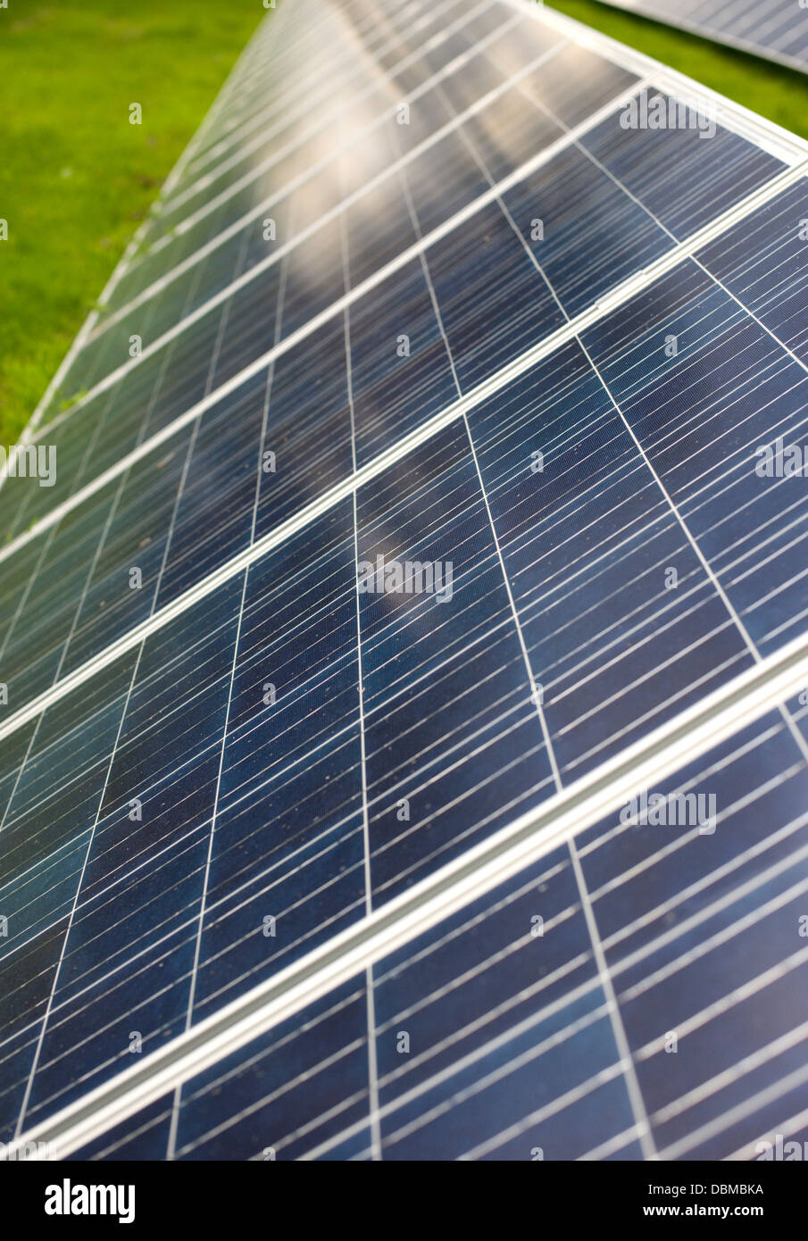 Unusual view of solar panel photovoltaic modules with light reflecting ...