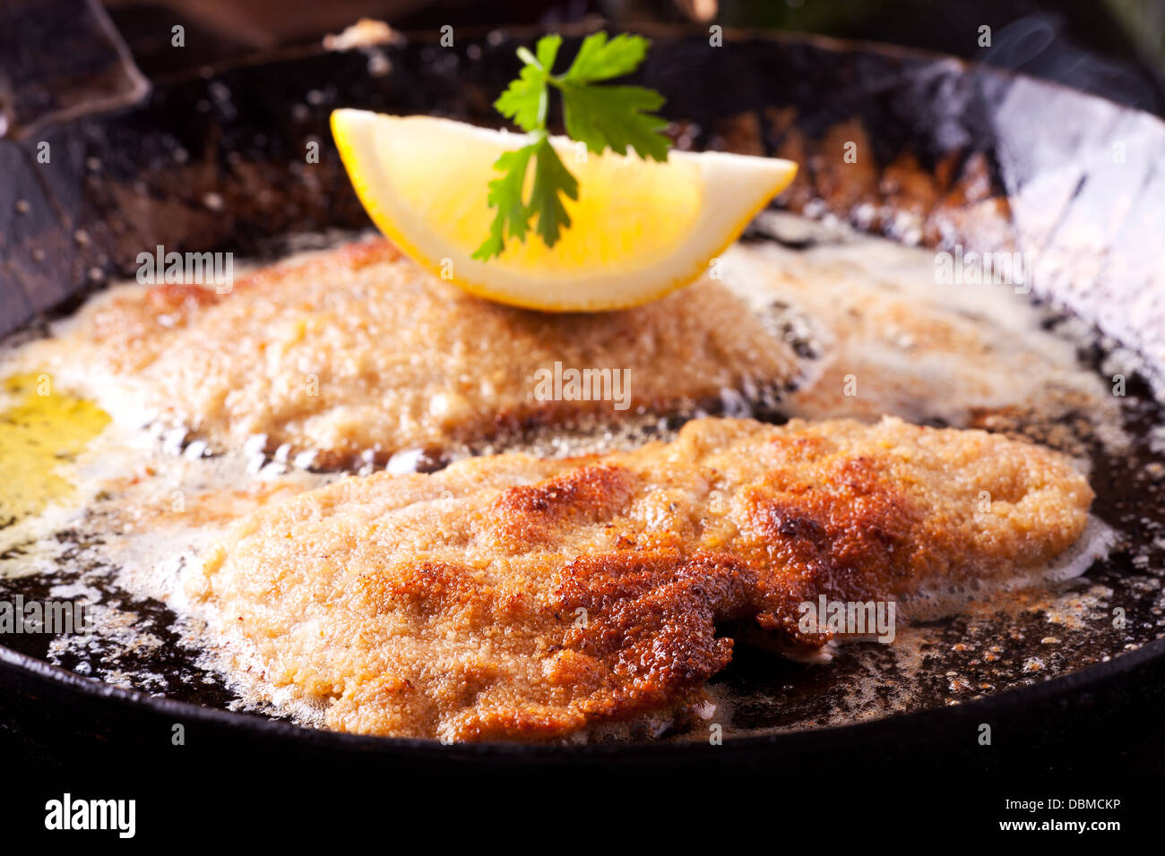 wiener schnitzel frying in a pan Stock Photo - Alamy