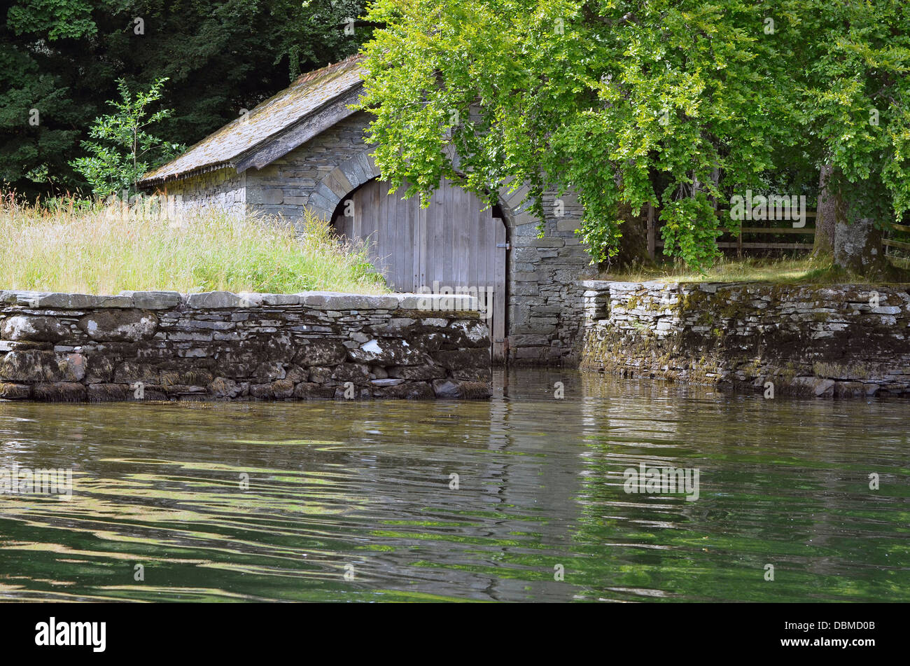 Traditional stone built boat houses on the shores of Coniston Water ...