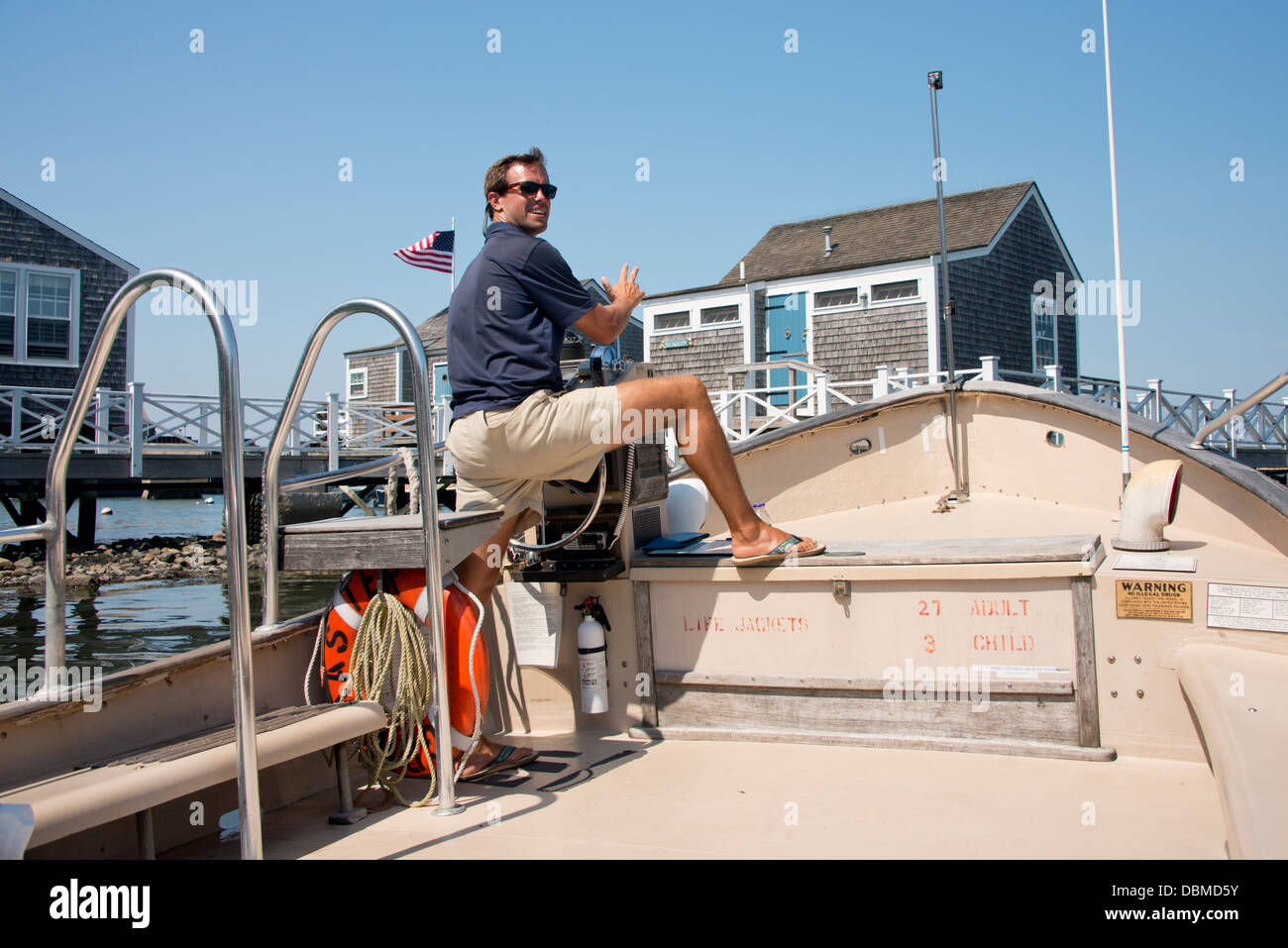 Massachusetts, Nantucket, Straight Wharf. Harbor water taxi in front of ...