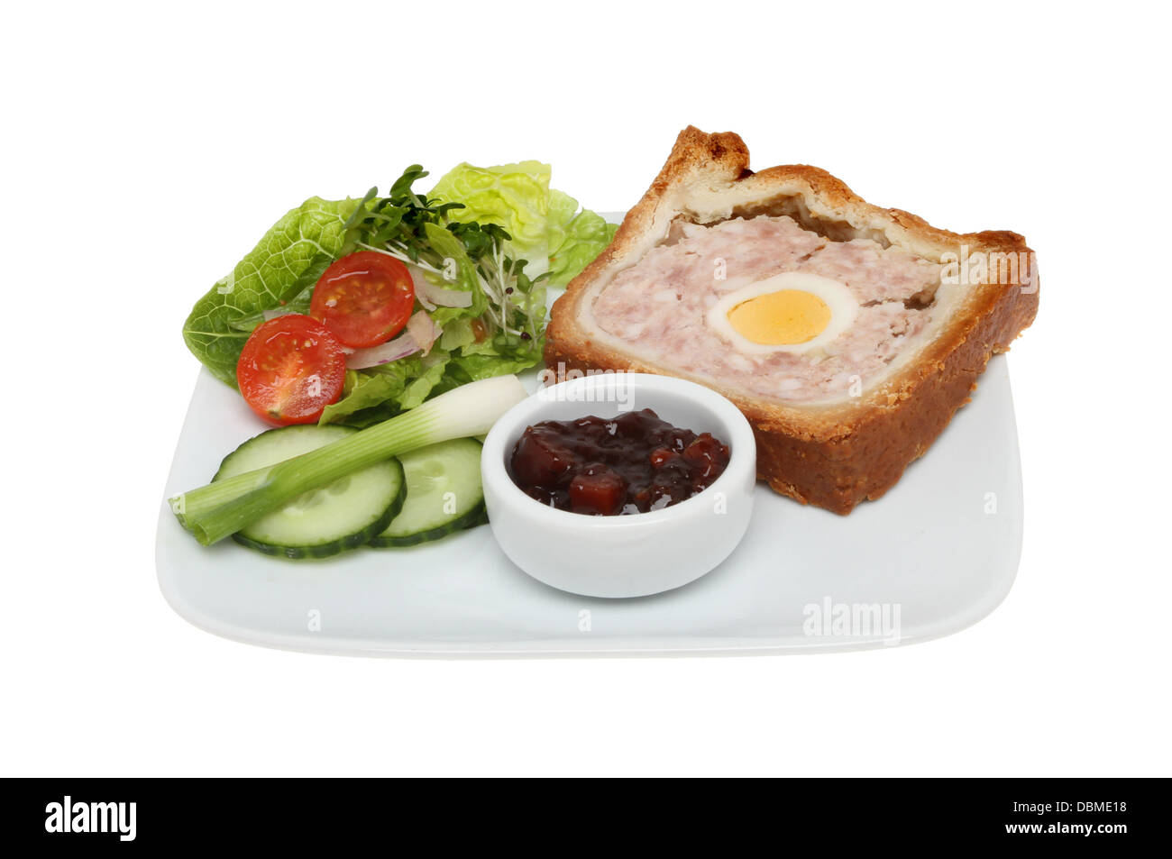 Gala pie, salad and pickle on a plate isolated against white Stock ...